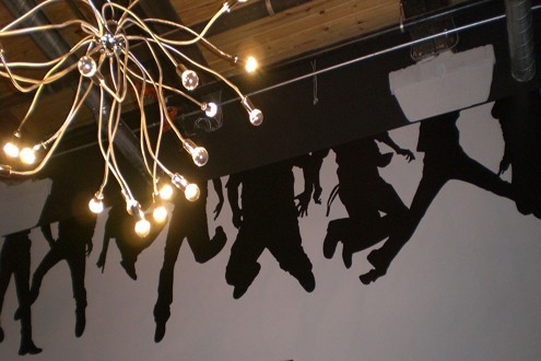 Retail store wall art and chandelier | Interior Design Ideas