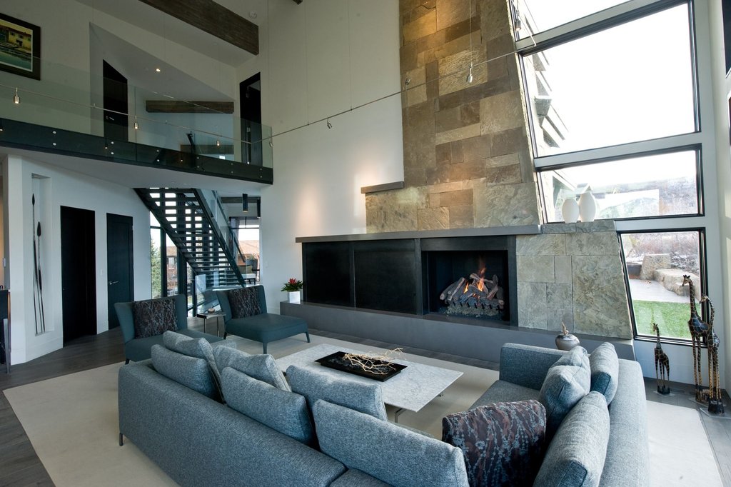 rail lit living with fireplace and view | Interior Design Ideas