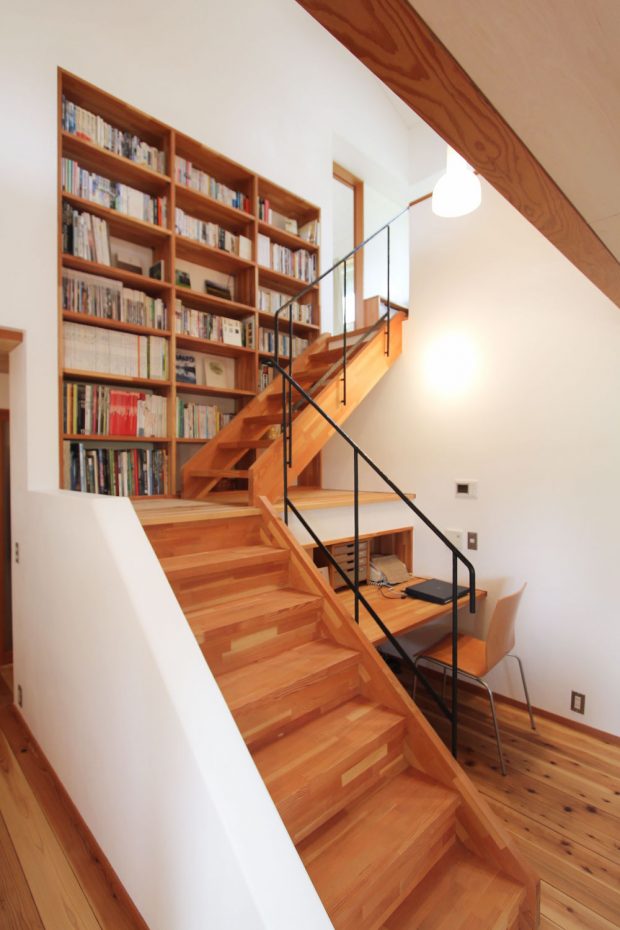 library wall in middle of stair step bookcase | Interior Design Ideas